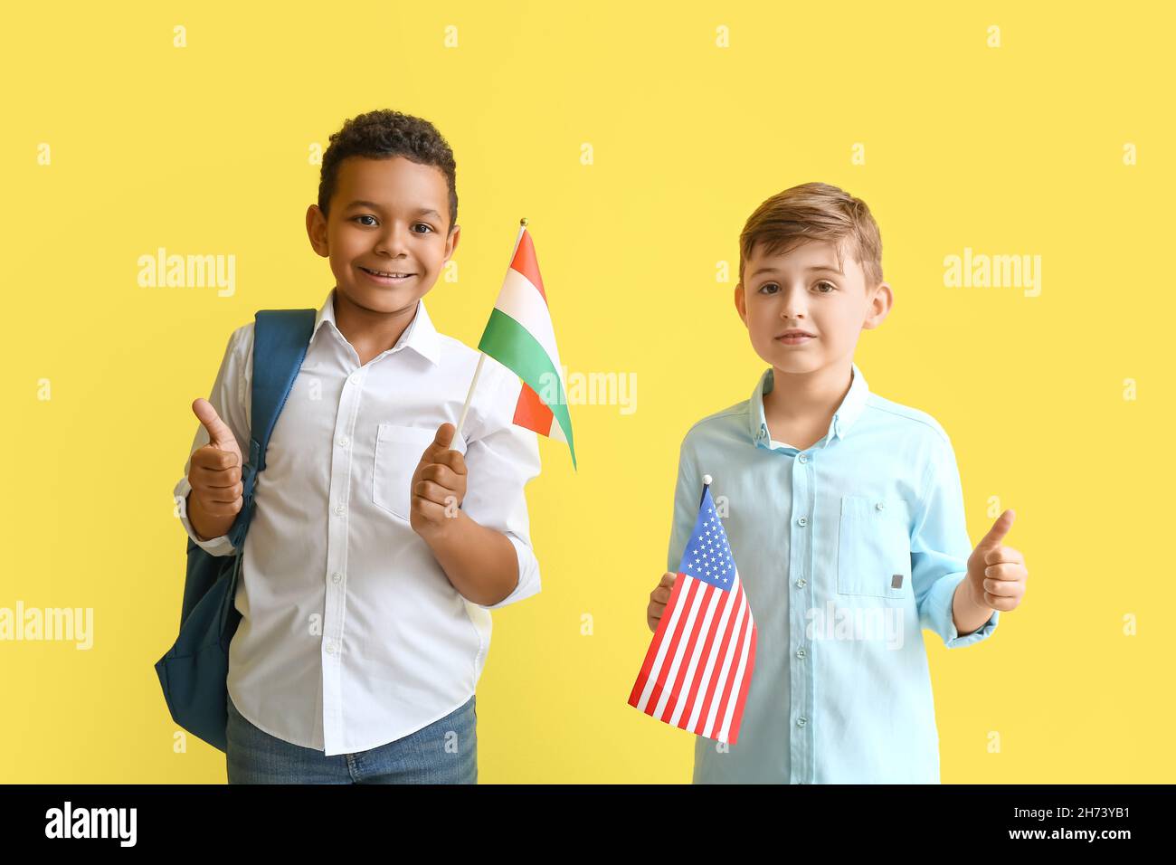Pupils of language school with different flags on color background ...