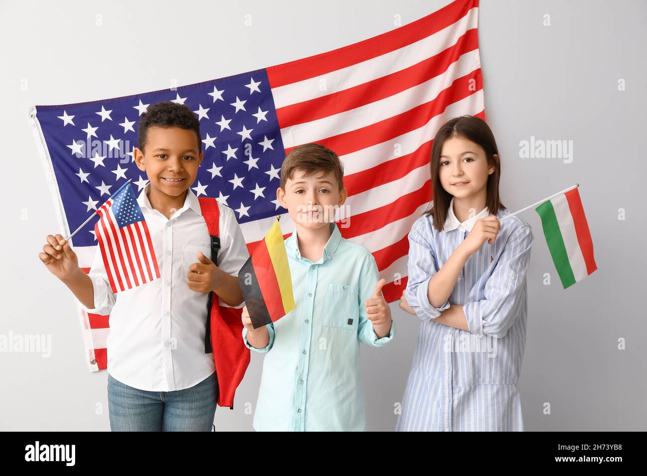 Pupils of language school near light wall with USA flag Stock Photo - Alamy