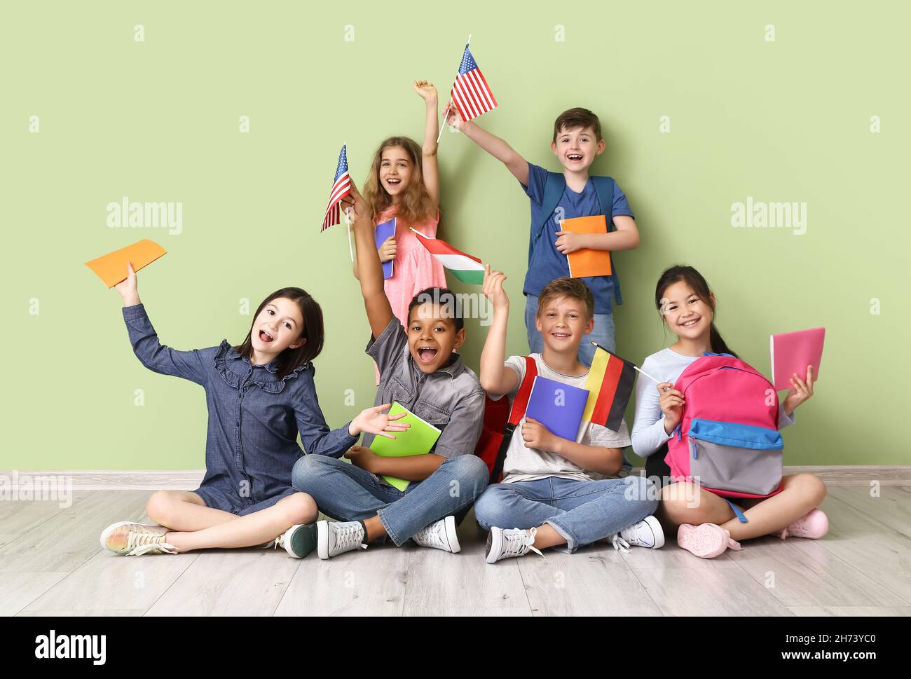 Pupils of language school near color wall Stock Photo - Alamy