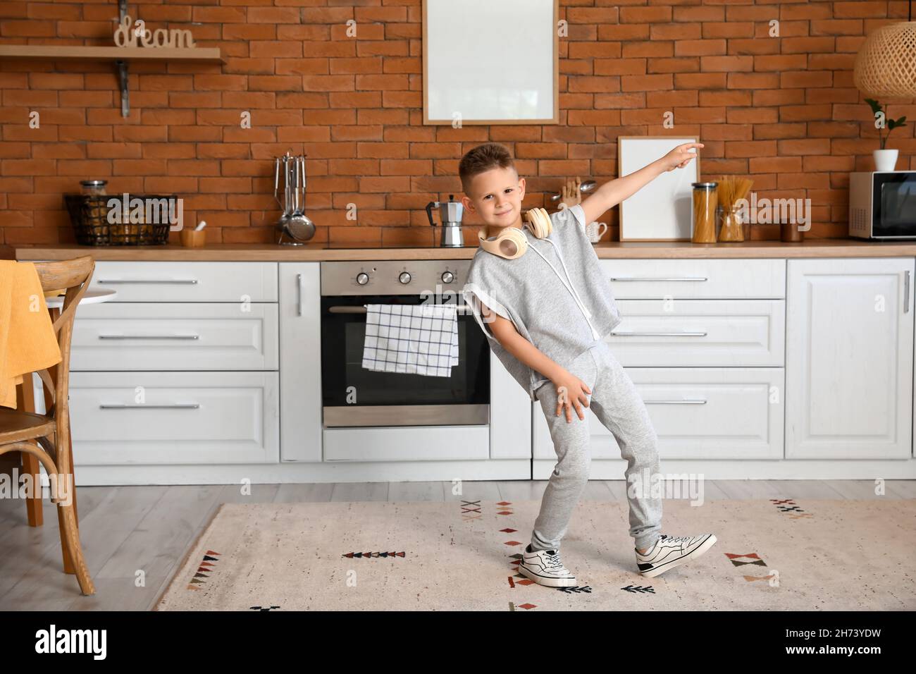 Cute little boy dancing in kitchen Stock Photo - Alamy