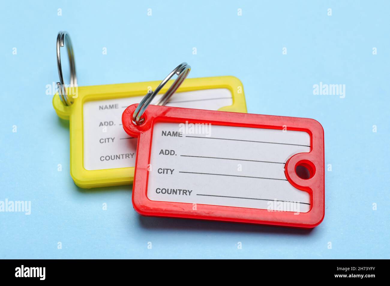 Plastic key tags on blue background Stock Photo - Alamy