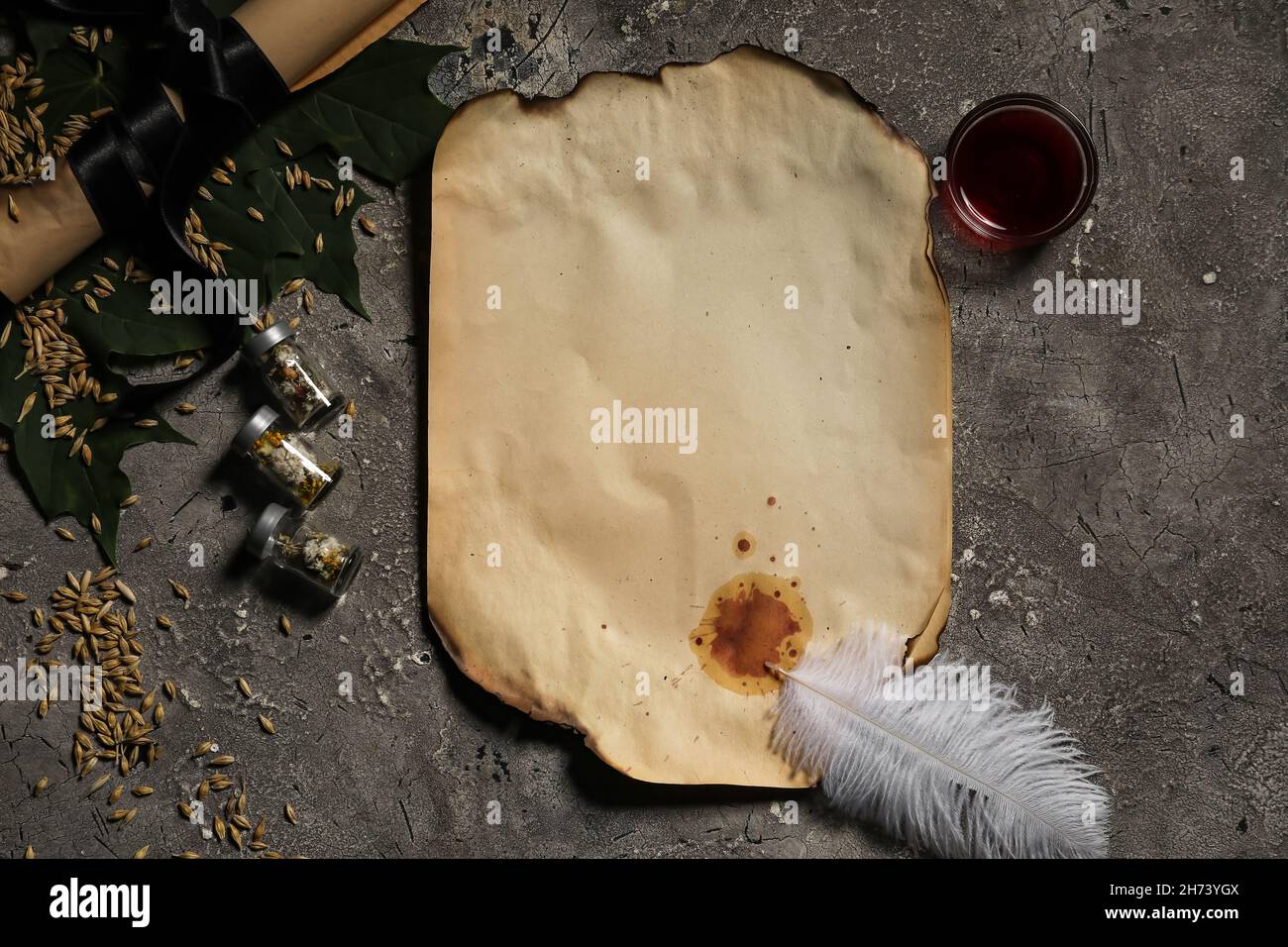 Ancient blank scroll and magic attributes for ritual on wizard table ...