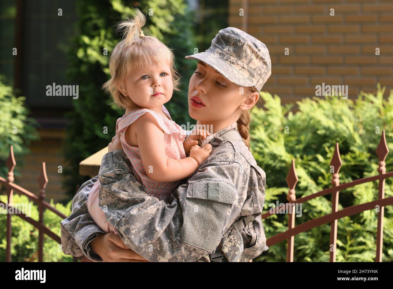 Female soldier hugging her baby girl outdoors Stock Photo - Alamy