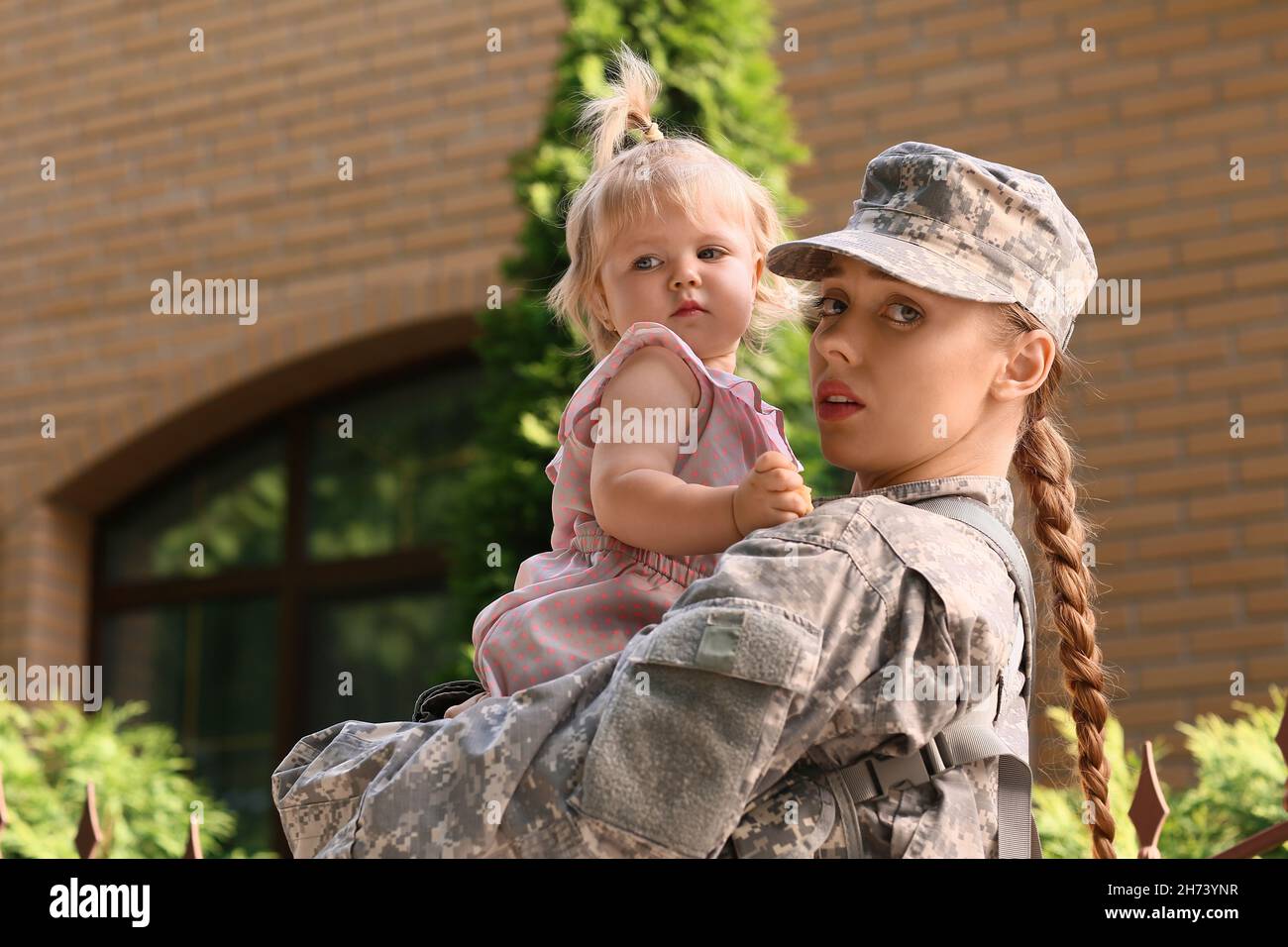 Female soldier hugging her baby girl outdoors Stock Photo - Alamy