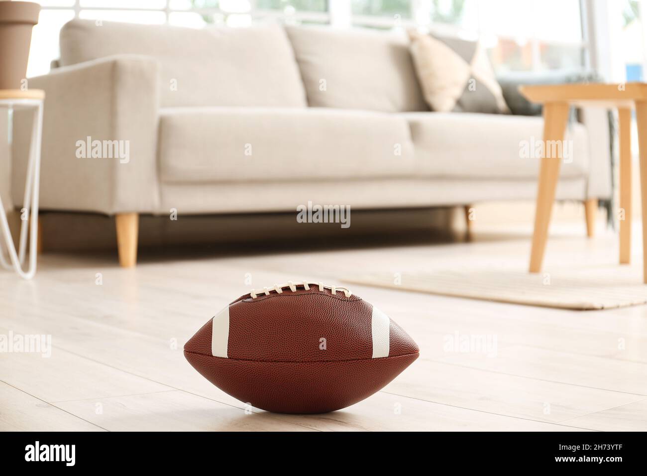 Rugby ball on floor in living room Stock Photo - Alamy