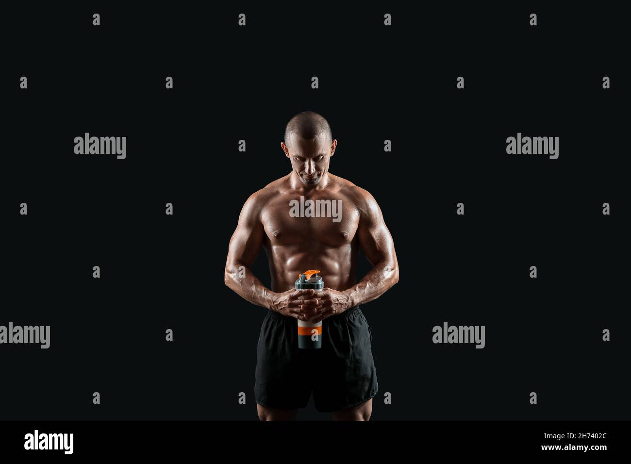Male bodybuilder with protein shake on dark background Stock Photo - Alamy