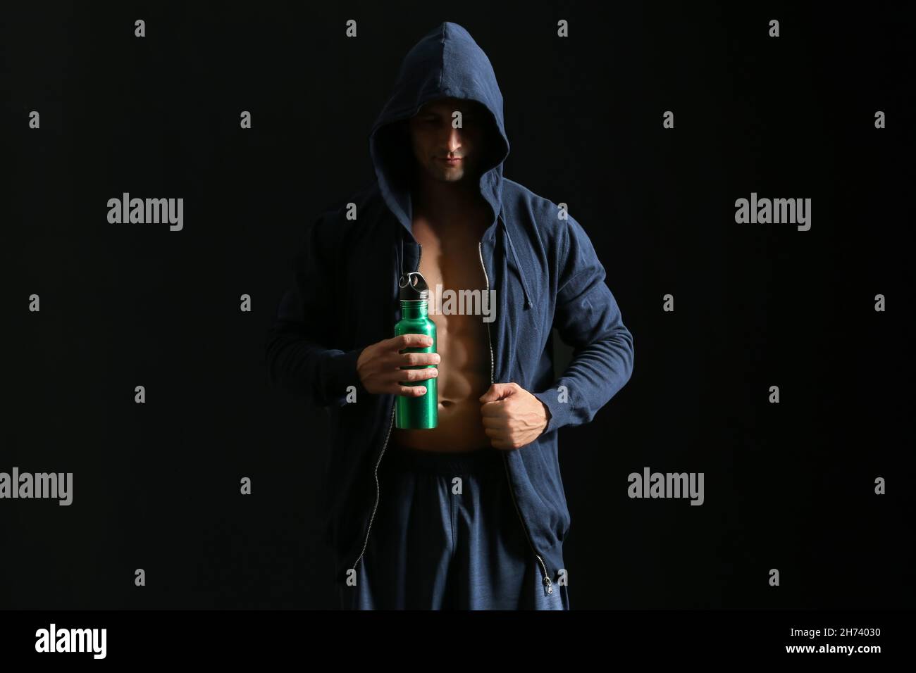 Male bodybuilder with protein shake on dark background Stock Photo - Alamy