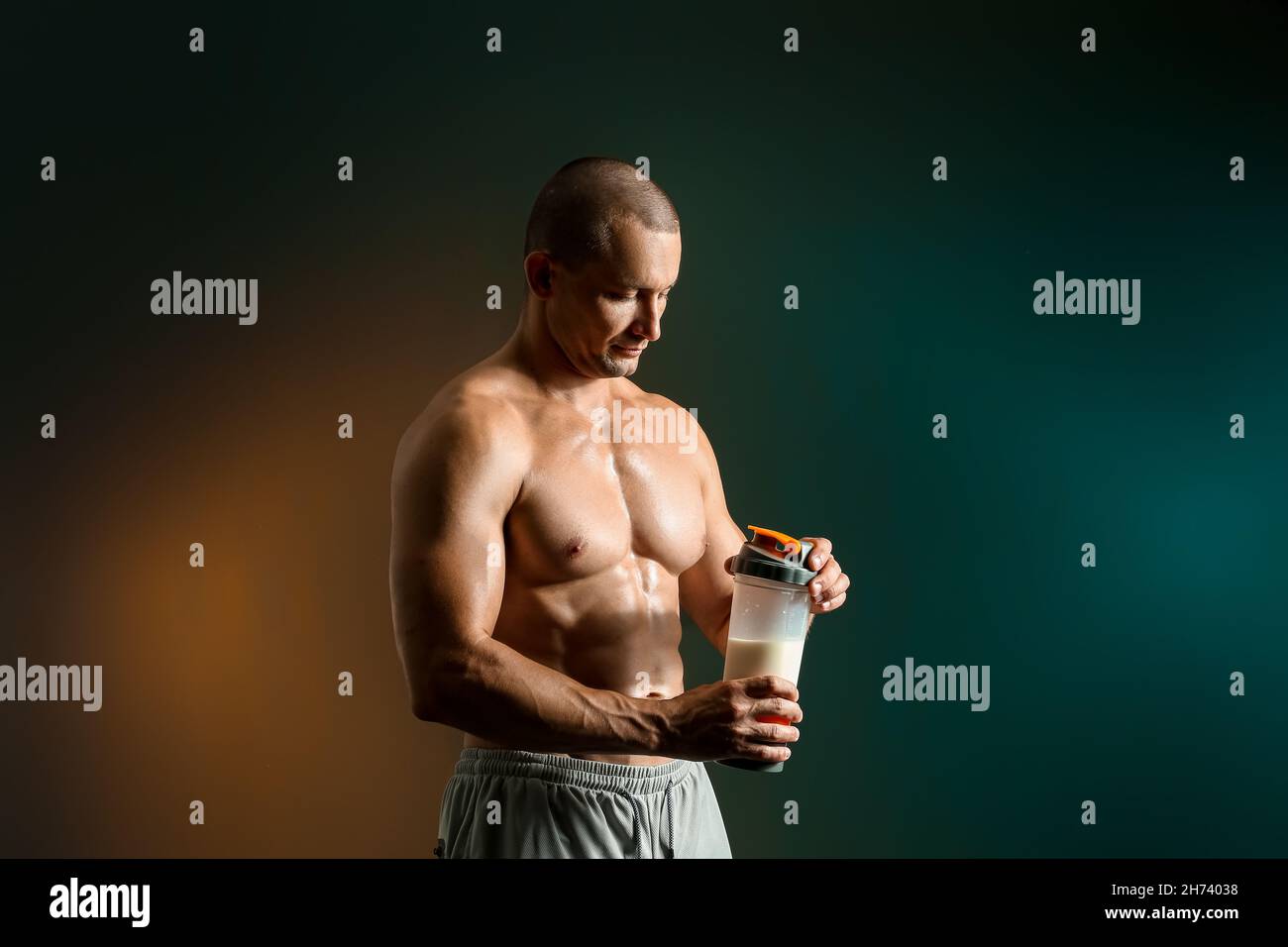 Male bodybuilder with protein shake on dark background Stock Photo - Alamy