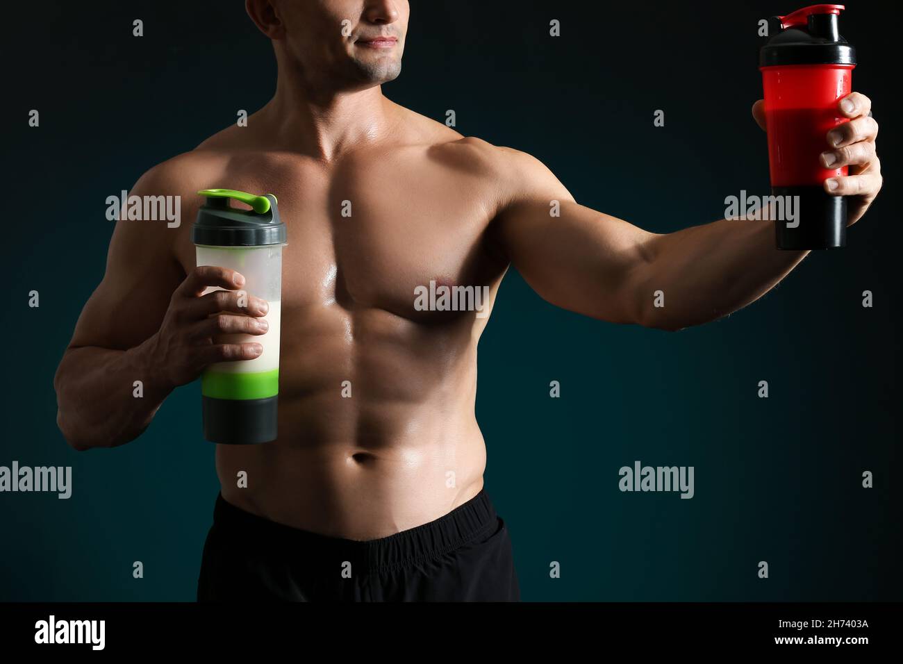 Male bodybuilder with protein shakes on dark background Stock Photo - Alamy