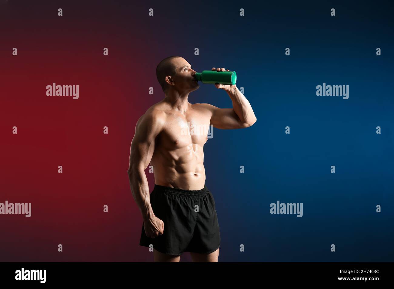 Male bodybuilder drinking protein shake on dark background Stock Photo ...