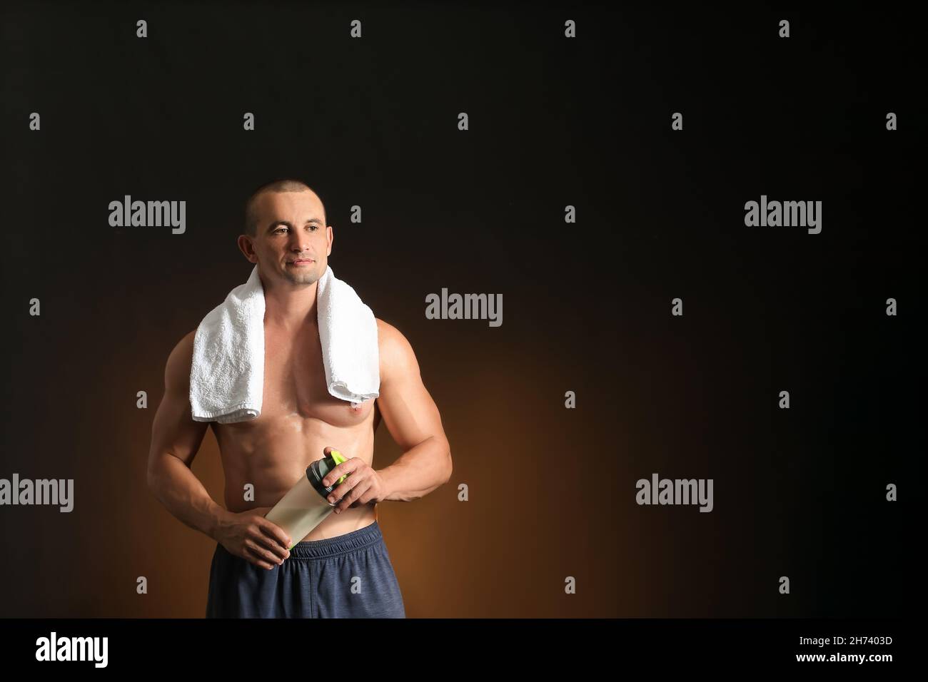 Male bodybuilder with protein shake on dark background Stock Photo - Alamy