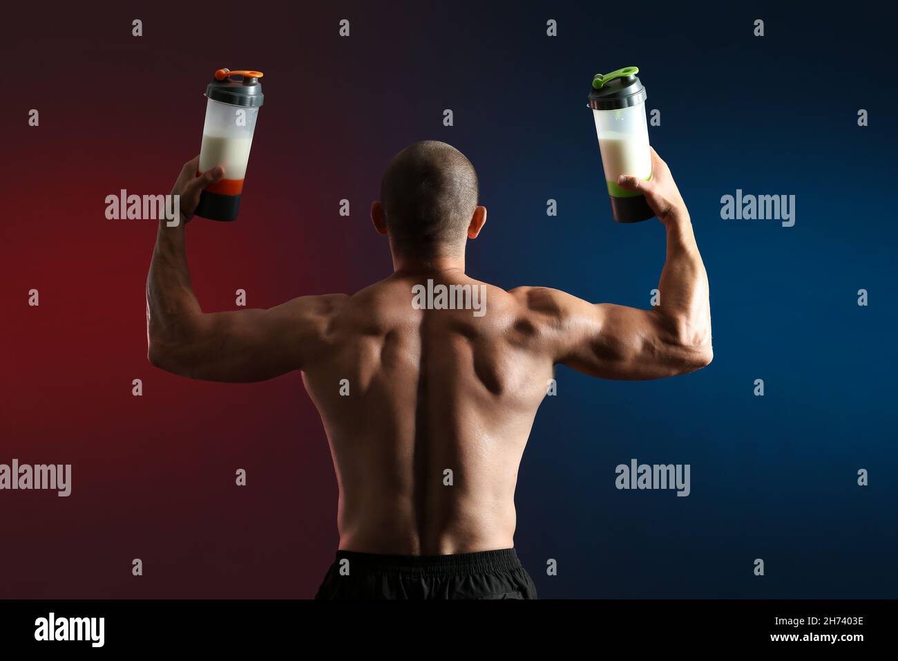 Male bodybuilder with protein shakes on dark background, back view ...