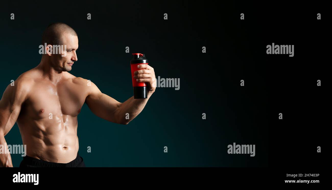 Male bodybuilder with protein shake on dark background Stock Photo - Alamy