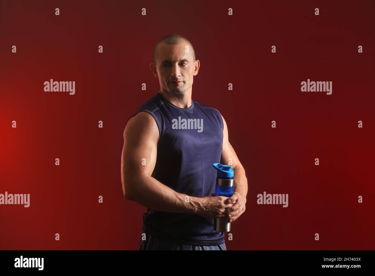 Male bodybuilder with protein shake on dark color background Stock ...