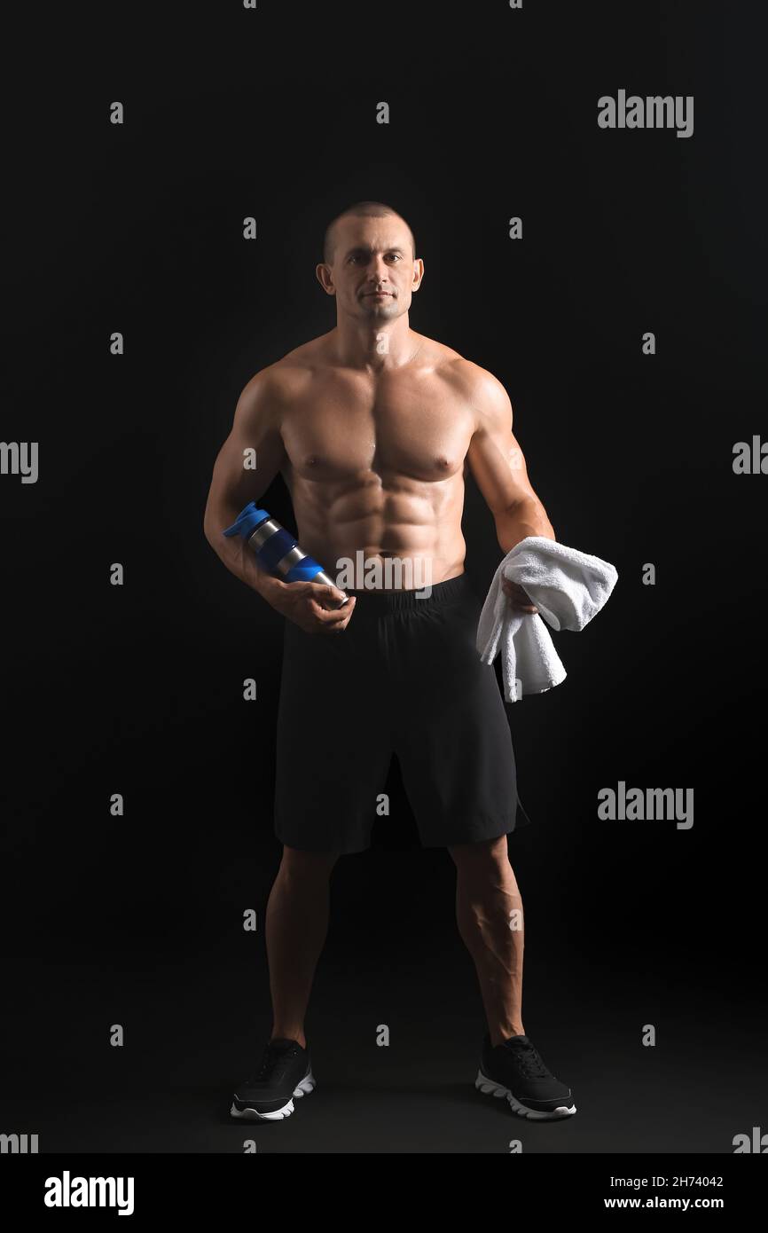 Male bodybuilder with protein shake on dark background Stock Photo - Alamy