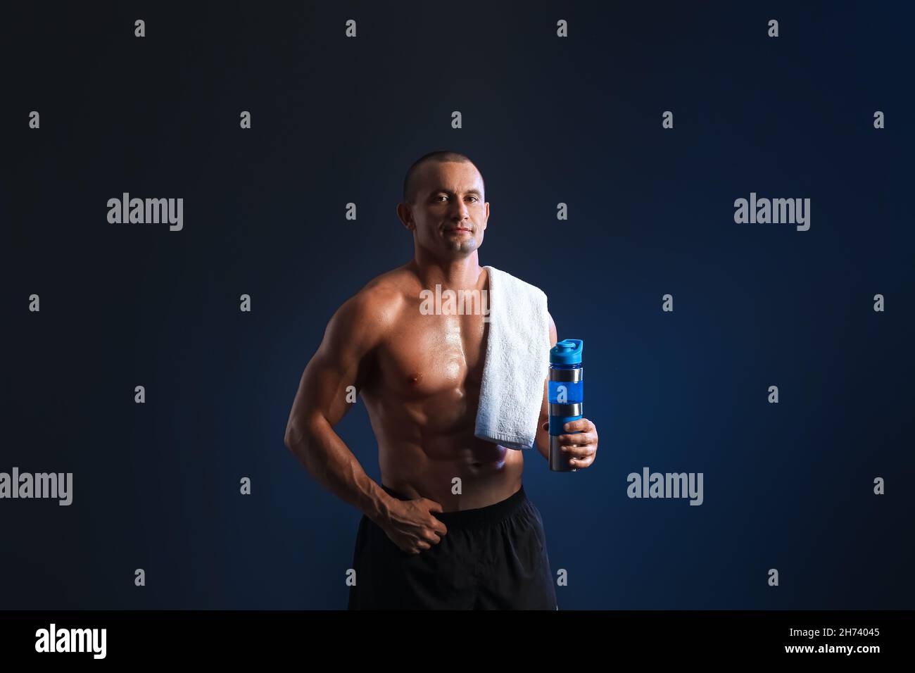 Male bodybuilder with protein shake on dark background Stock Photo - Alamy