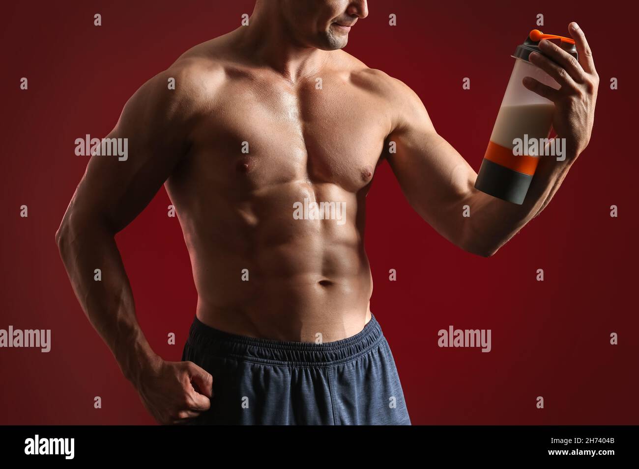 Male bodybuilder with protein shake on dark color background Stock ...