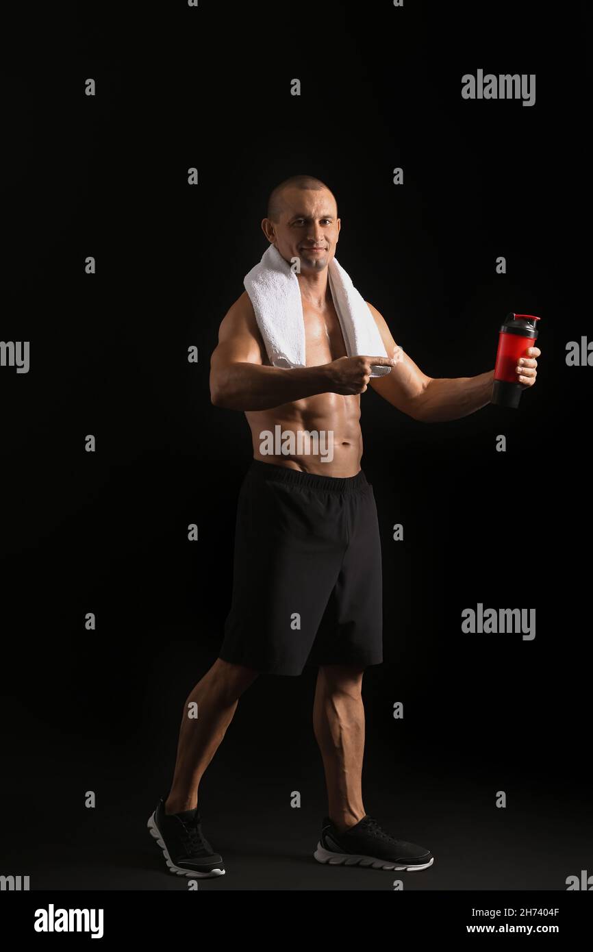 Male bodybuilder with protein shake on dark background Stock Photo - Alamy