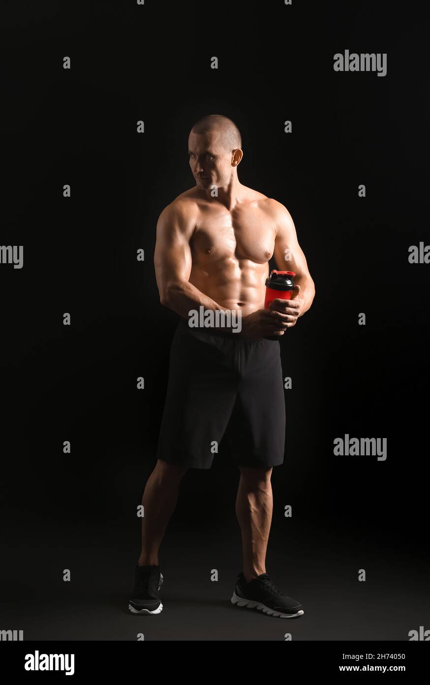 Male bodybuilder with protein shake on dark background Stock Photo - Alamy