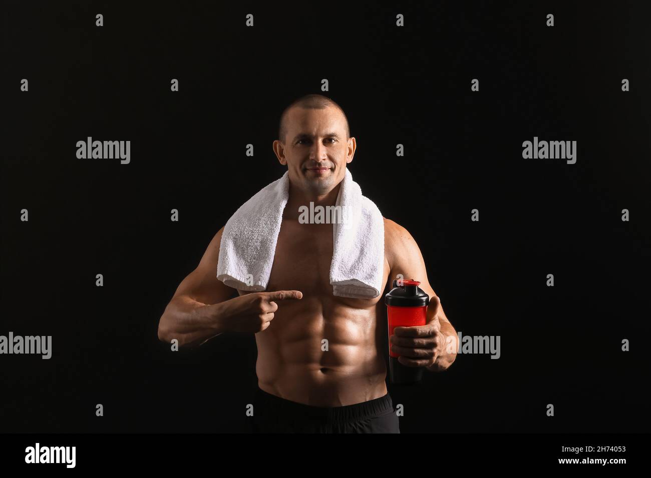 Male bodybuilder with protein shake on dark background Stock Photo - Alamy