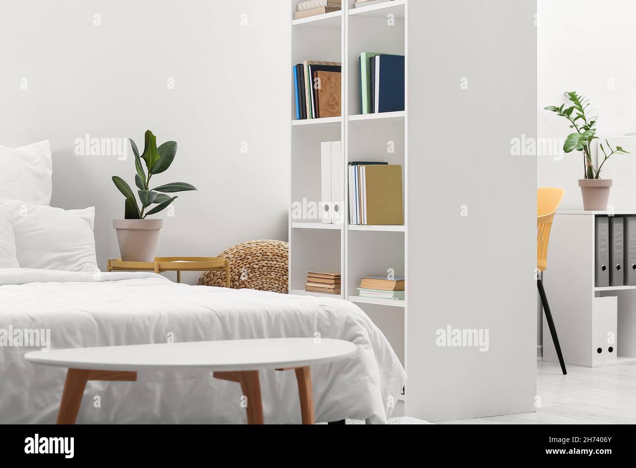 Bookshelf in stylish interior of modern studio apartment Stock Photo ...