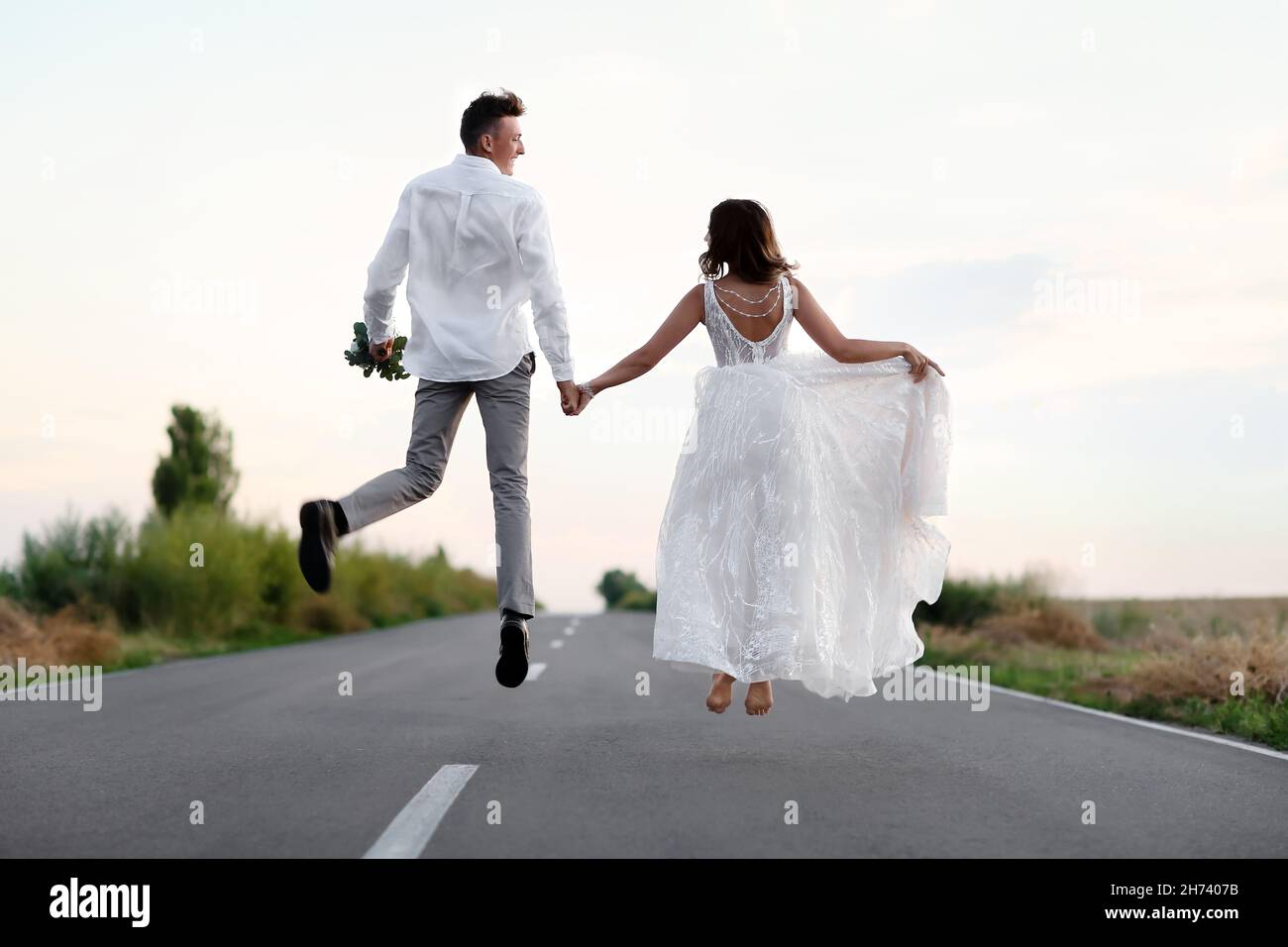 Happy wedding jumping groom hi-res stock photography and images - Alamy
