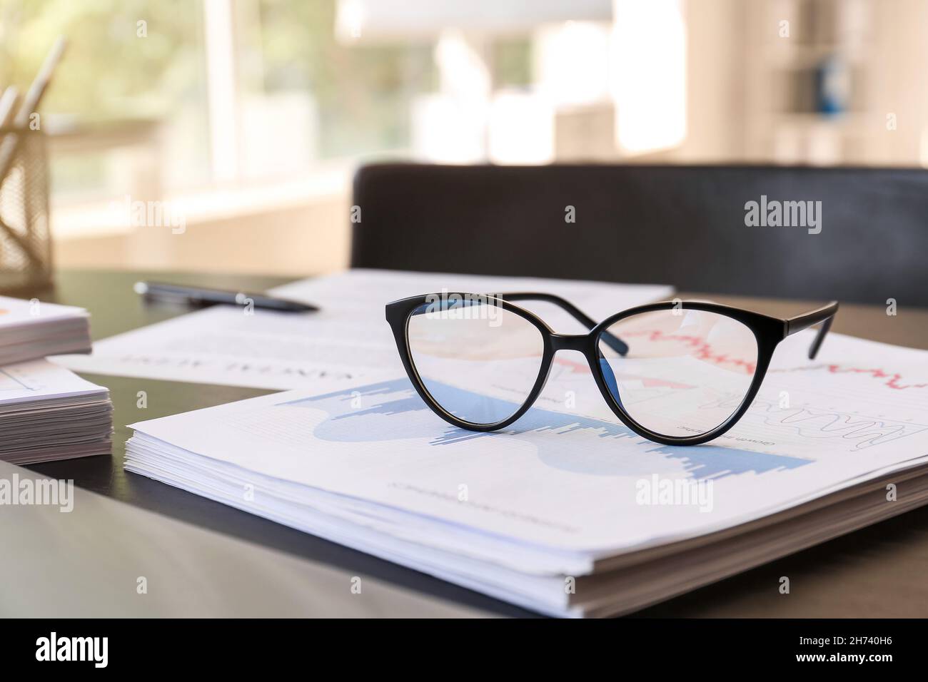 Stack of documents with eyeglasses at workplace in office Stock Photo ...