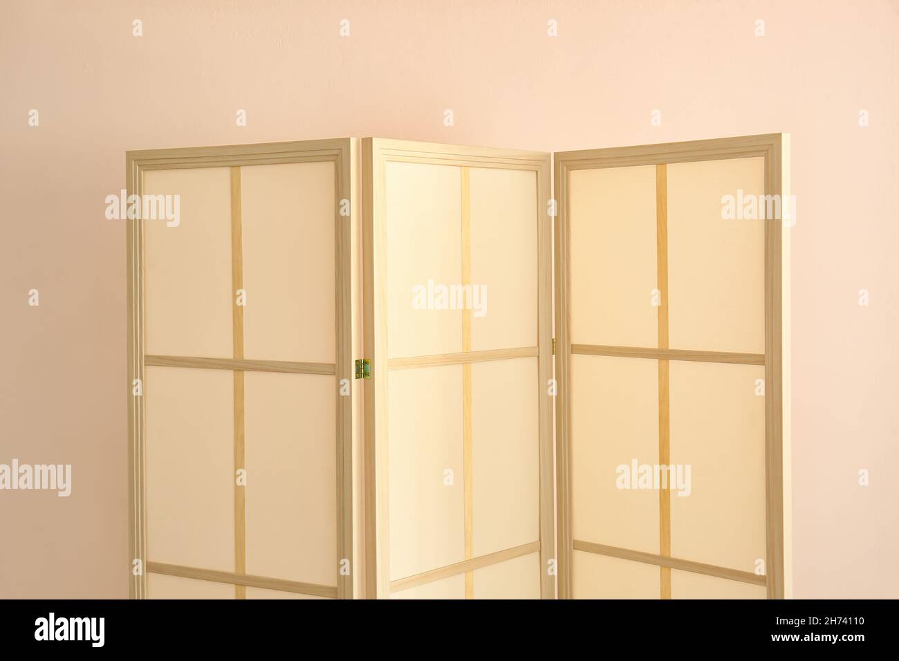 Stylish folding screen near wall in room Stock Photo - Alamy