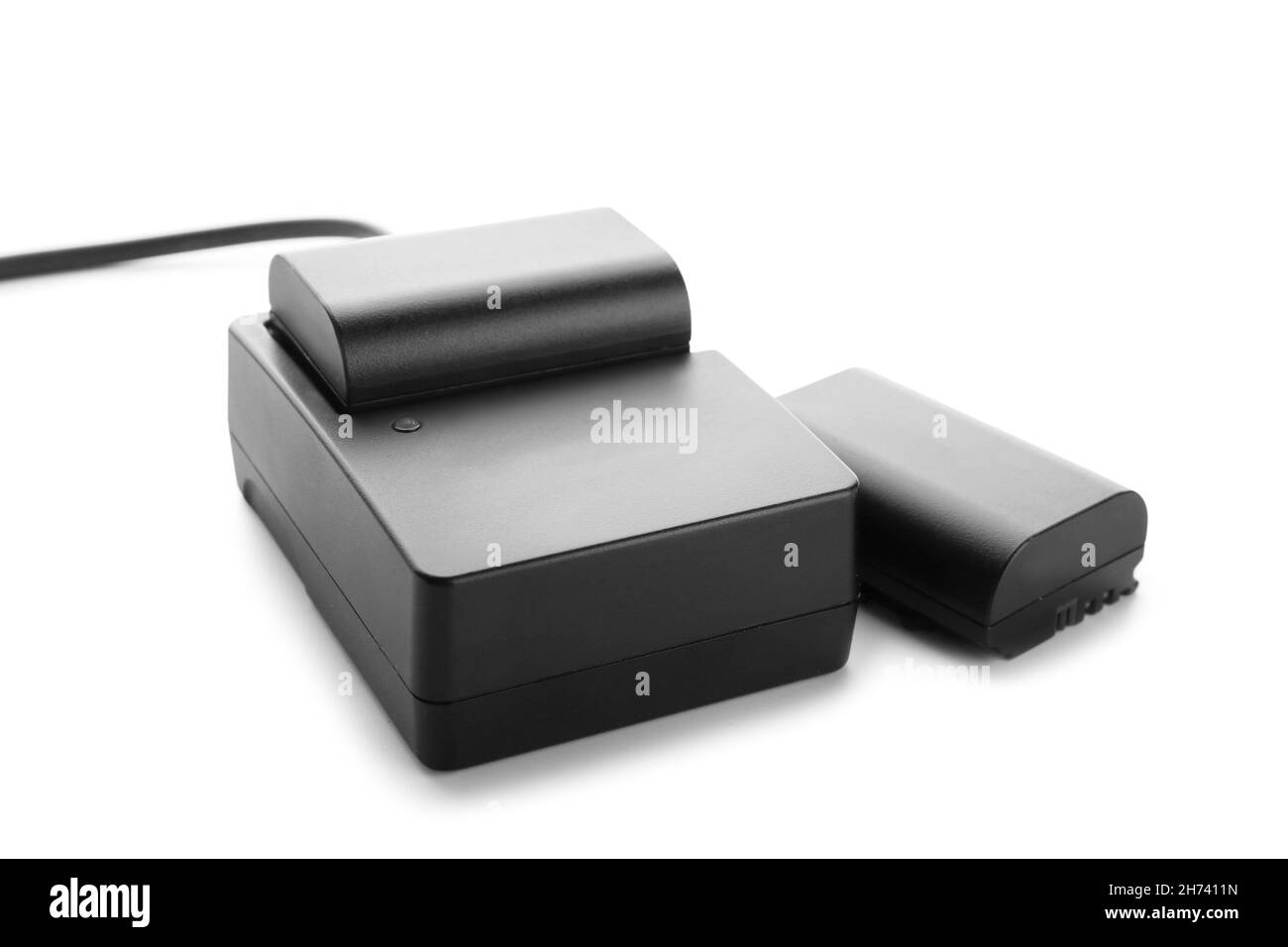 Camera batteries and charger isolated on white background Stock Photo ...