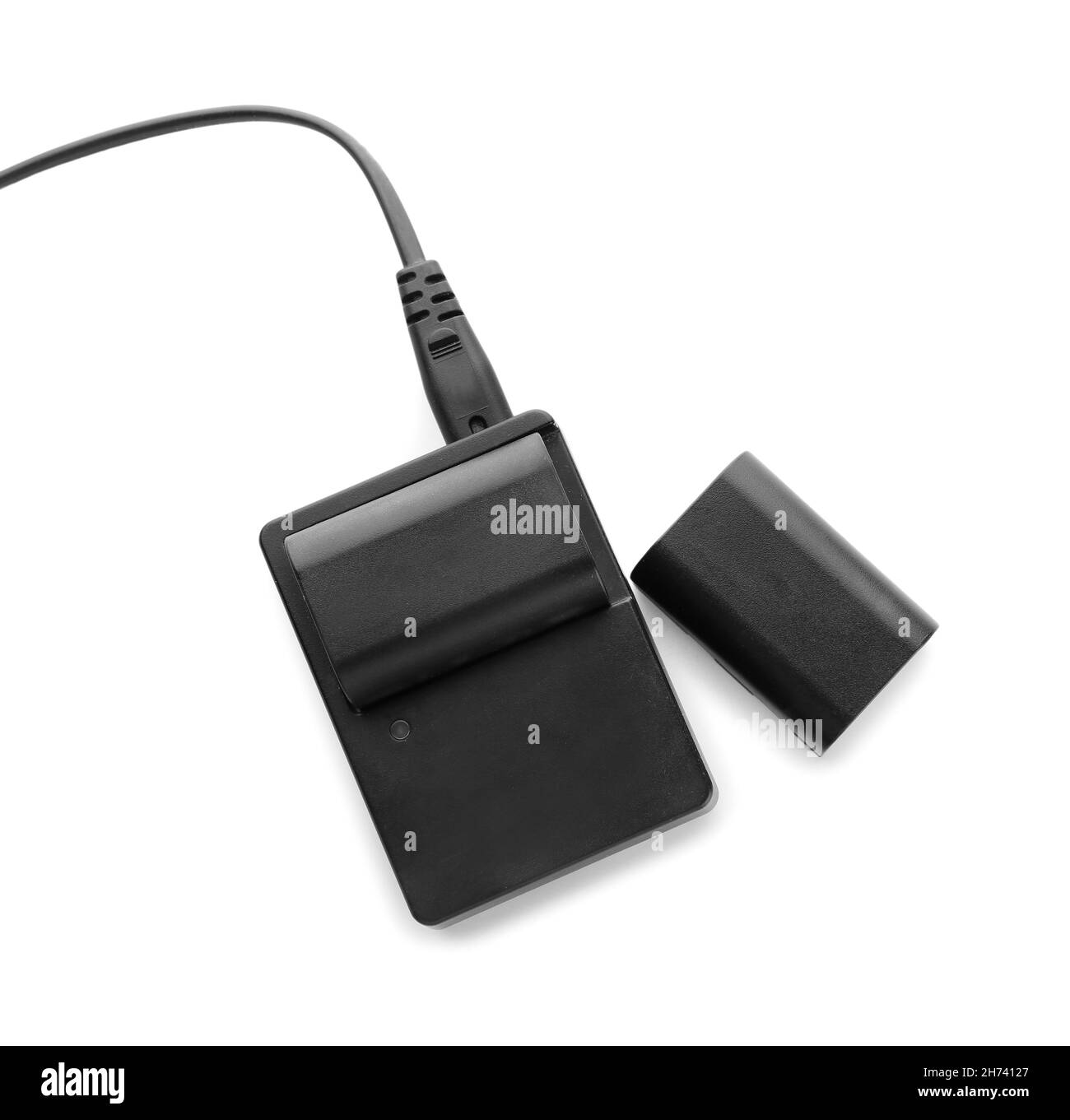 Camera batteries and charger isolated on white background Stock Photo ...