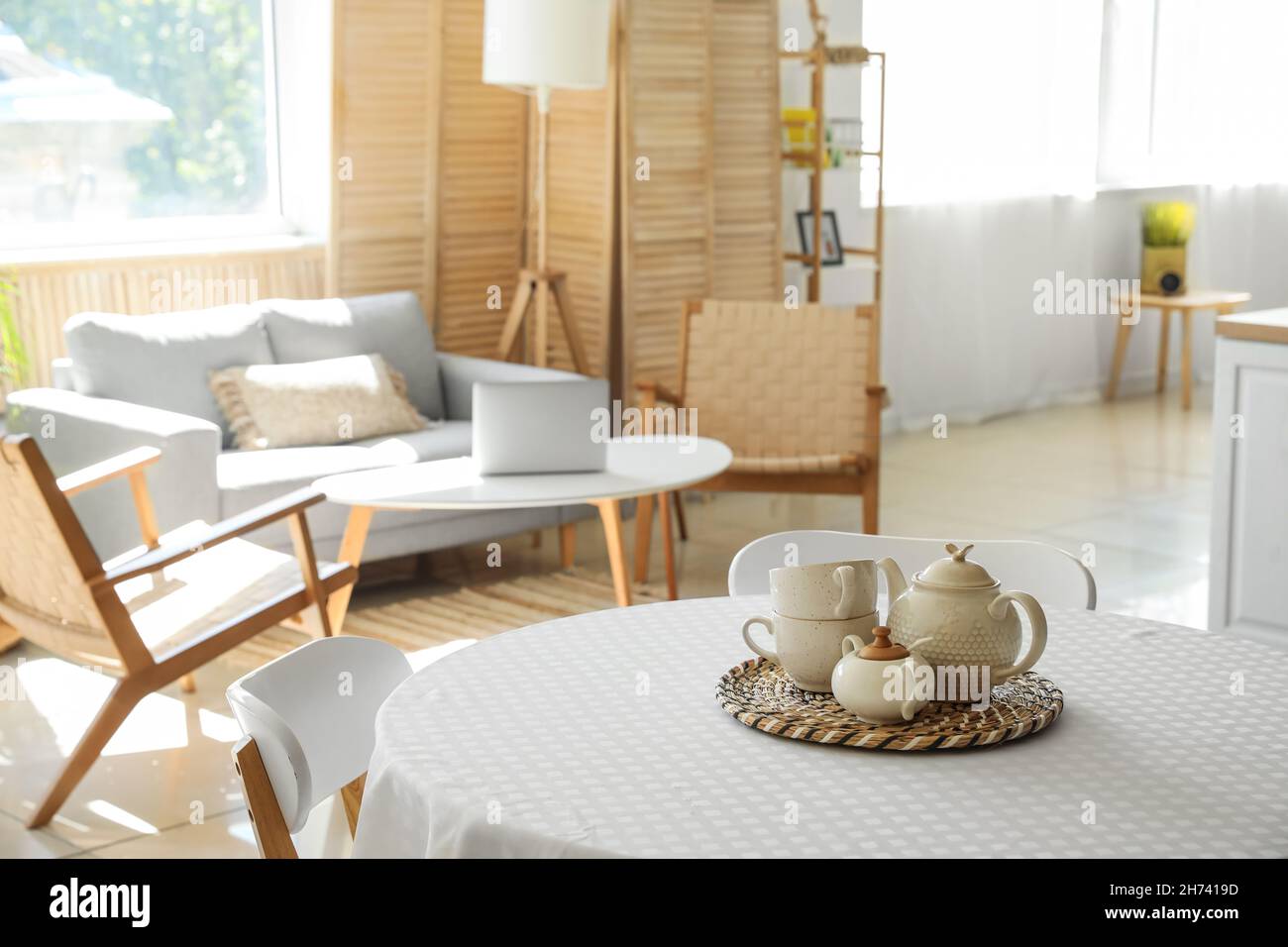 Tea set on dining table in studio apartment Stock Photo - Alamy