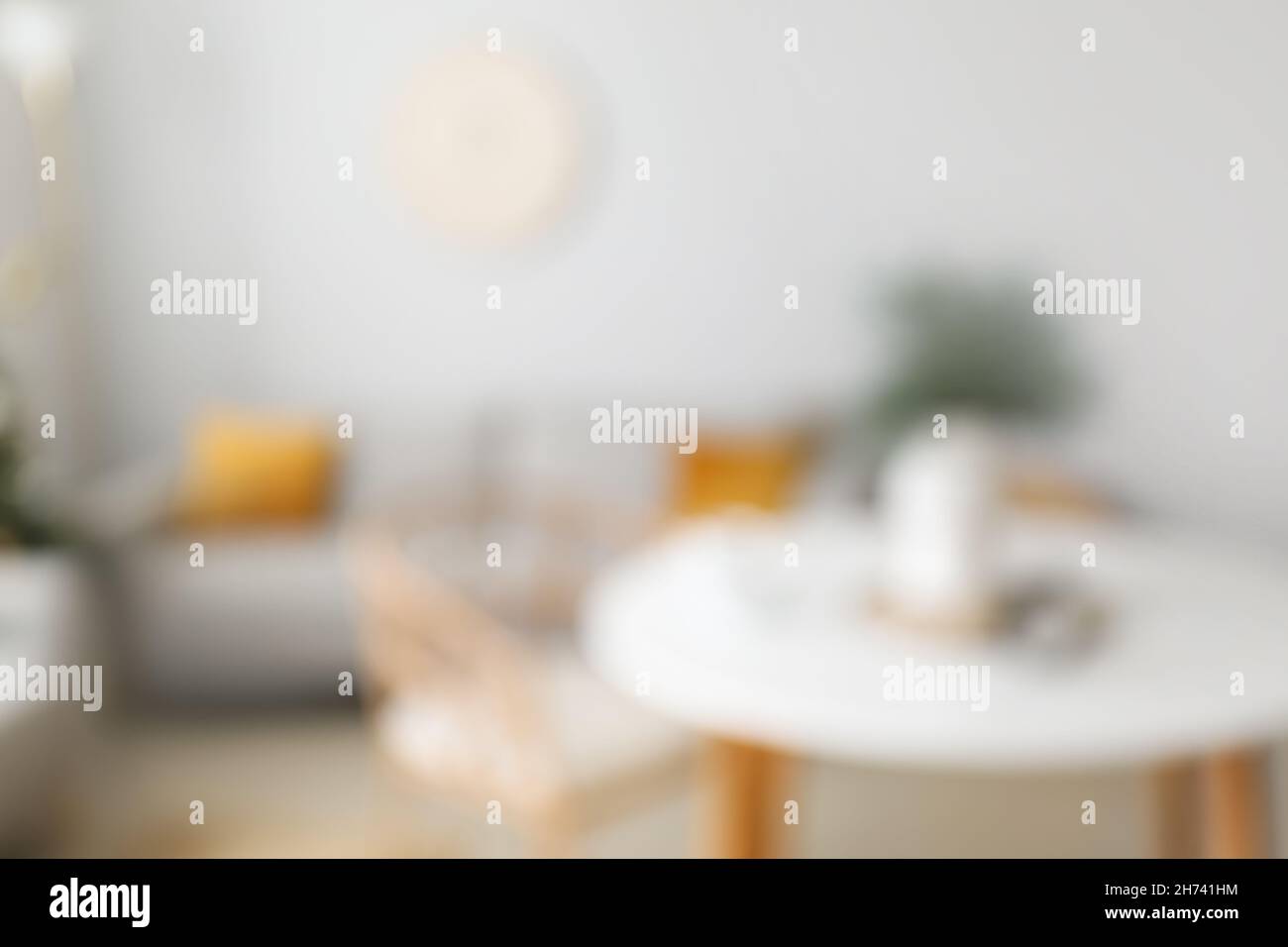 Blurred view of modern living room with dining table Stock Photo - Alamy