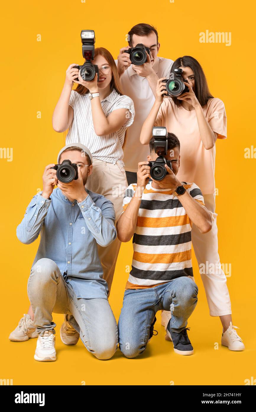 Group of photographers on color background Stock Photo - Alamy