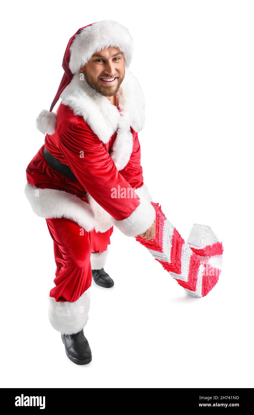 Santa Claus with candy cane pinata on white background Stock Photo - Alamy