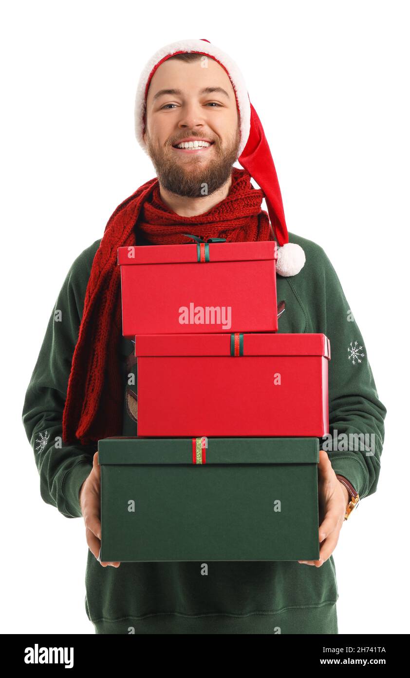 Handsome young man with Christmas gifts on white background Stock Photo ...