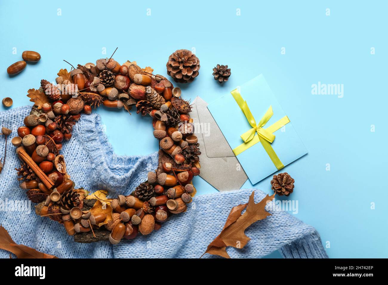 Beautiful acorn wreath and envelope on blue background Stock Photo - Alamy