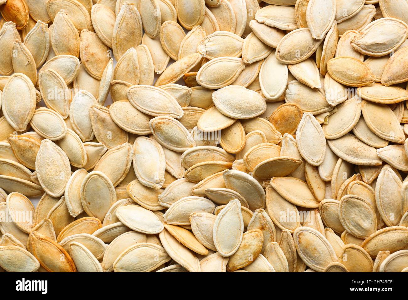 Natural pumpkin seeds as background, closeup Stock Photo - Alamy