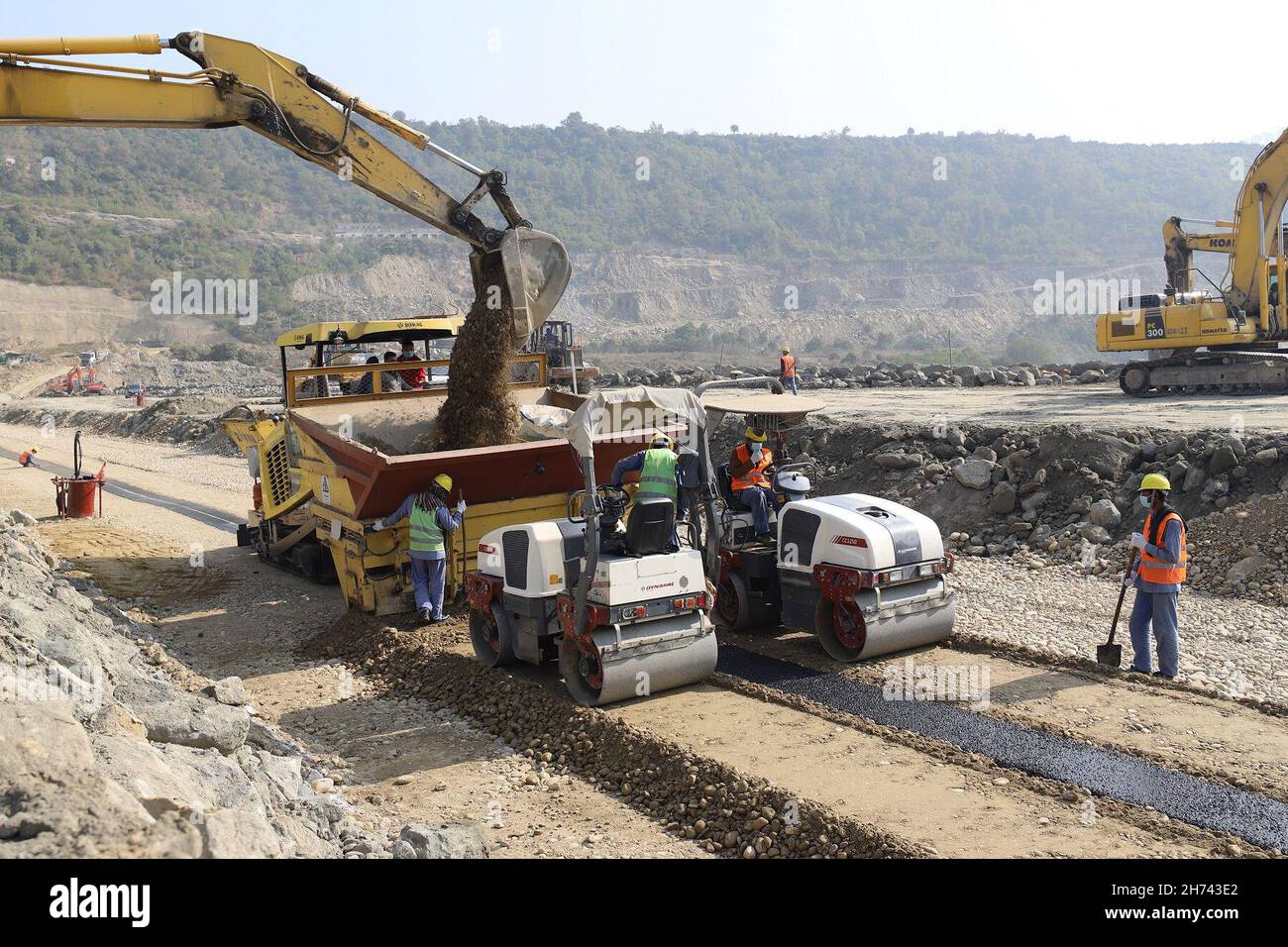 Karot, Pakistan. 19th Nov, 2021. Workers work at the dam of the Karot ...