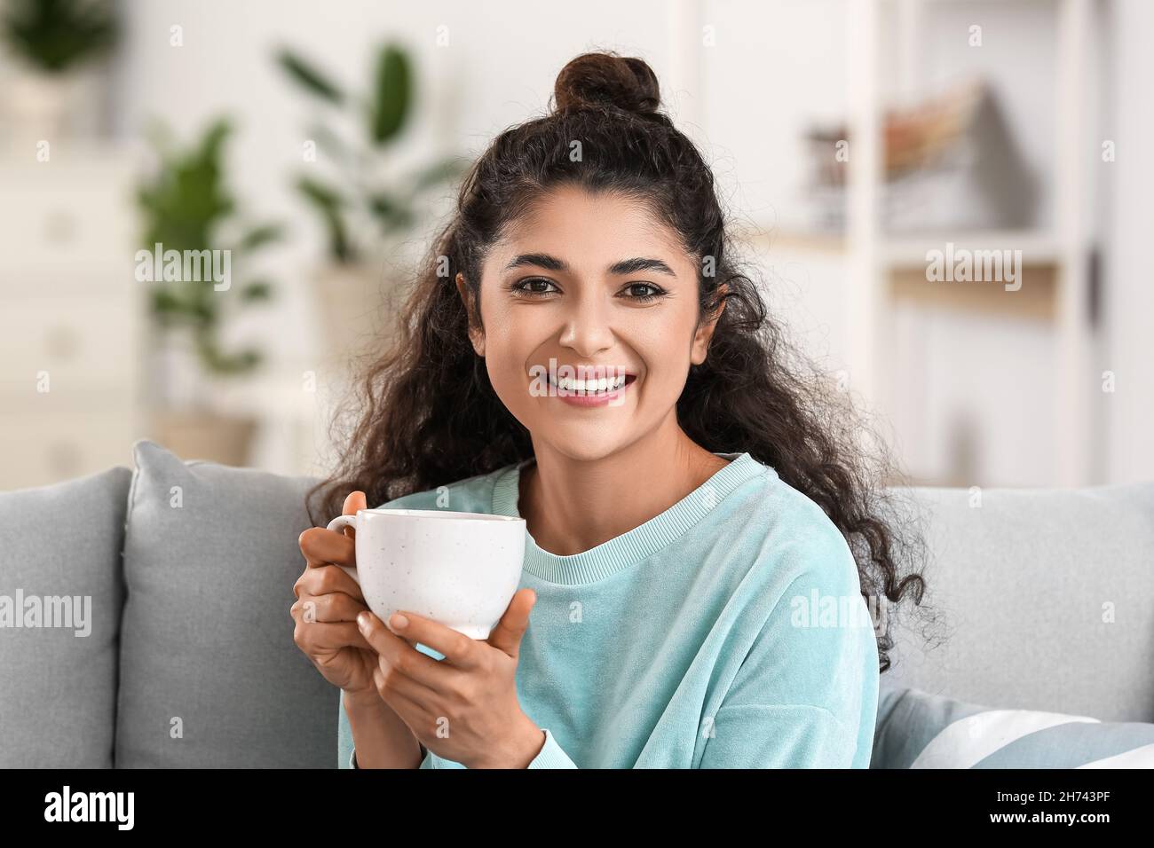 Beautiful woman drinking tea at home Stock Photo - Alamy