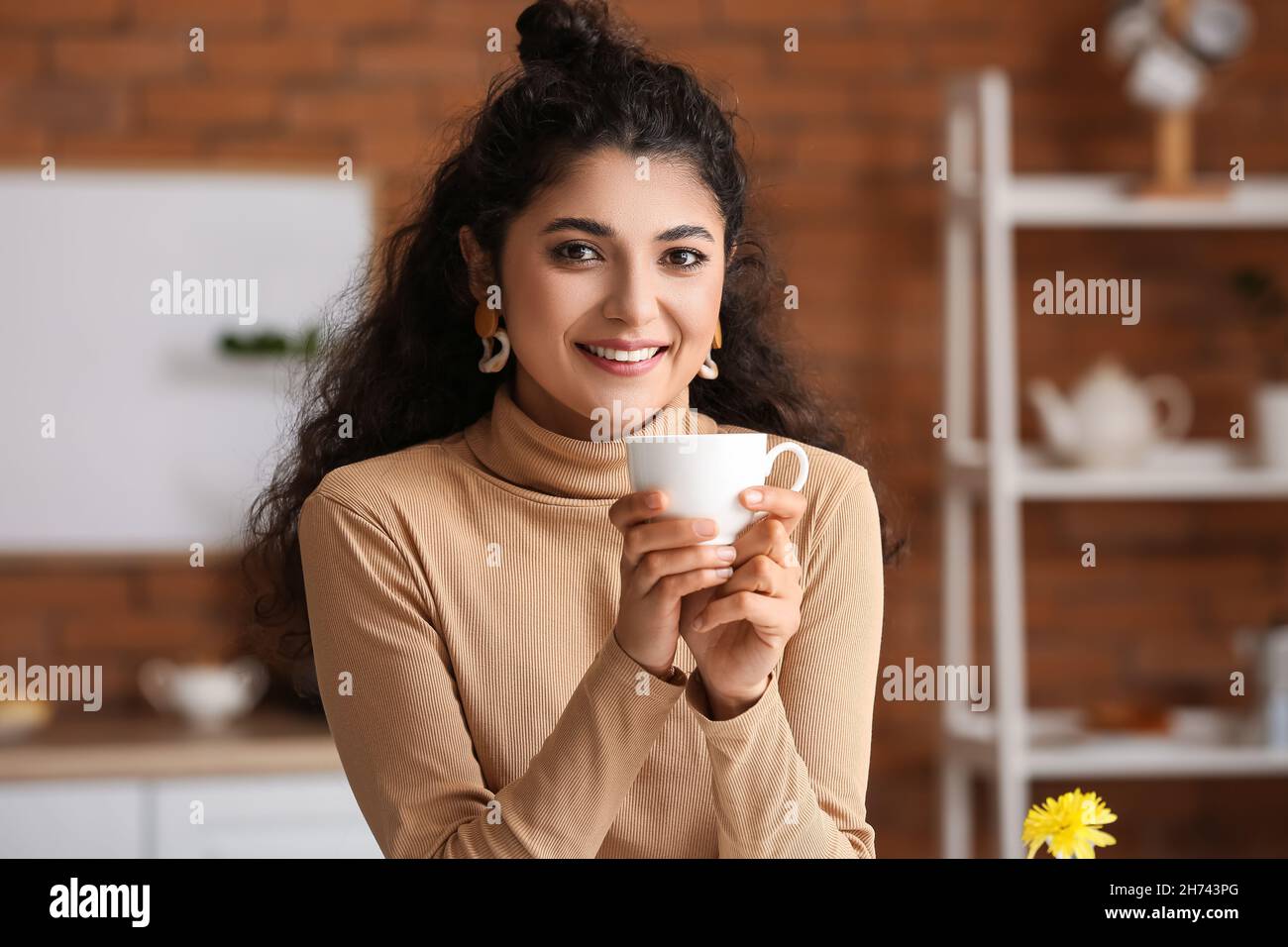 Beautiful woman drinking tea at home Stock Photo - Alamy