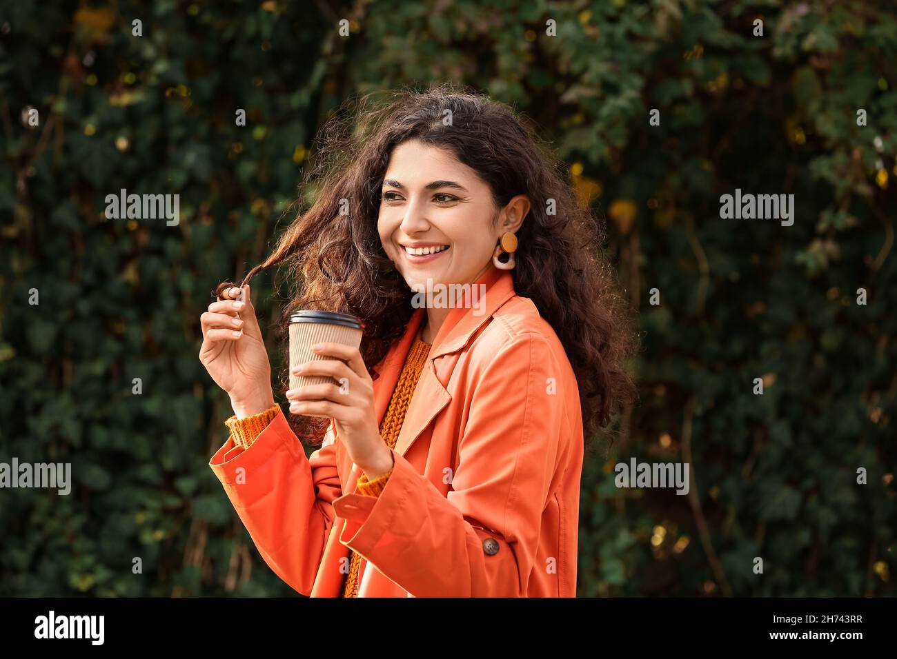 Beautiful woman drinking tea outdoors Stock Photo - Alamy