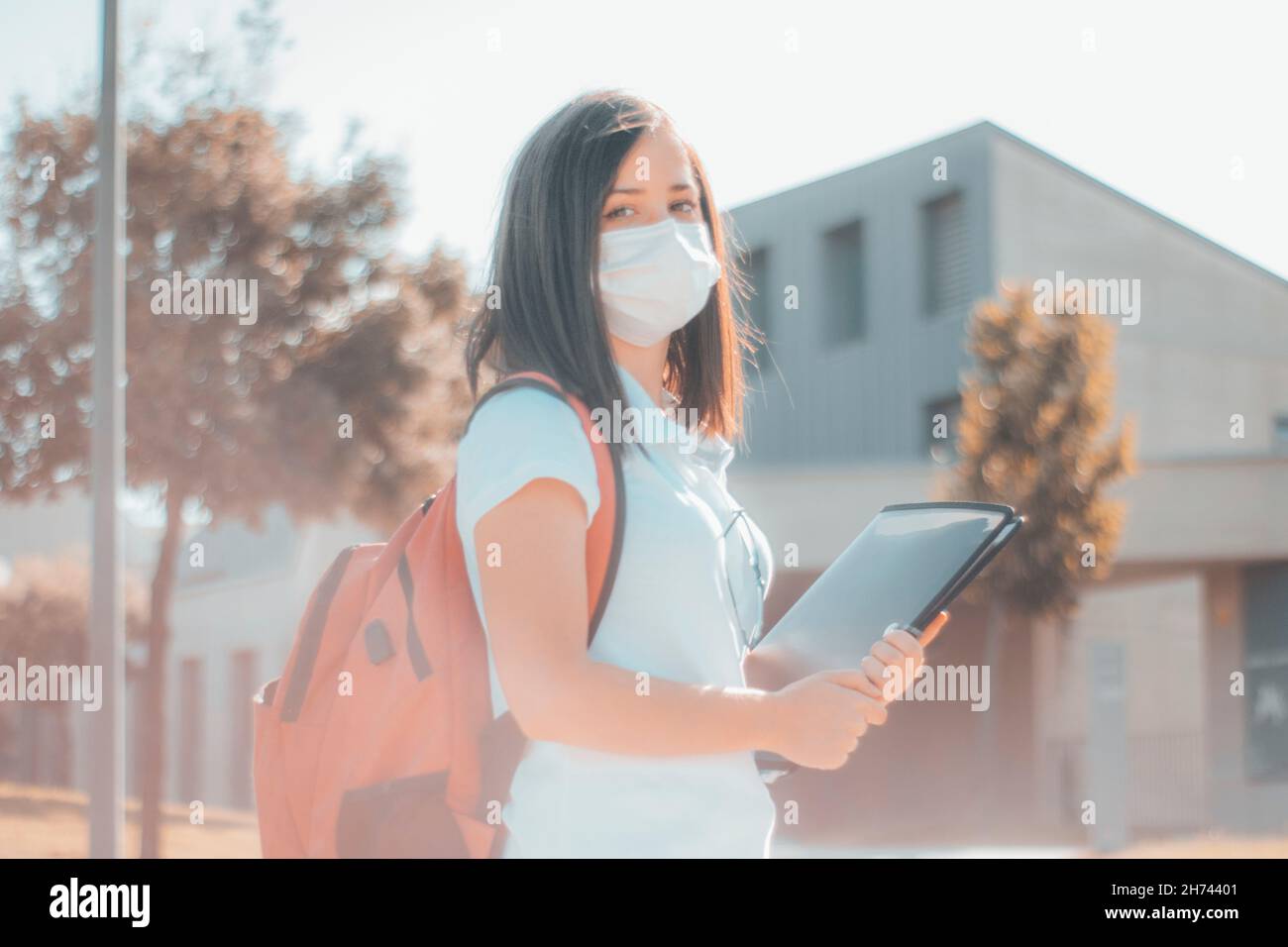 Young student girl with face mask on college campus Stock Photo - Alamy