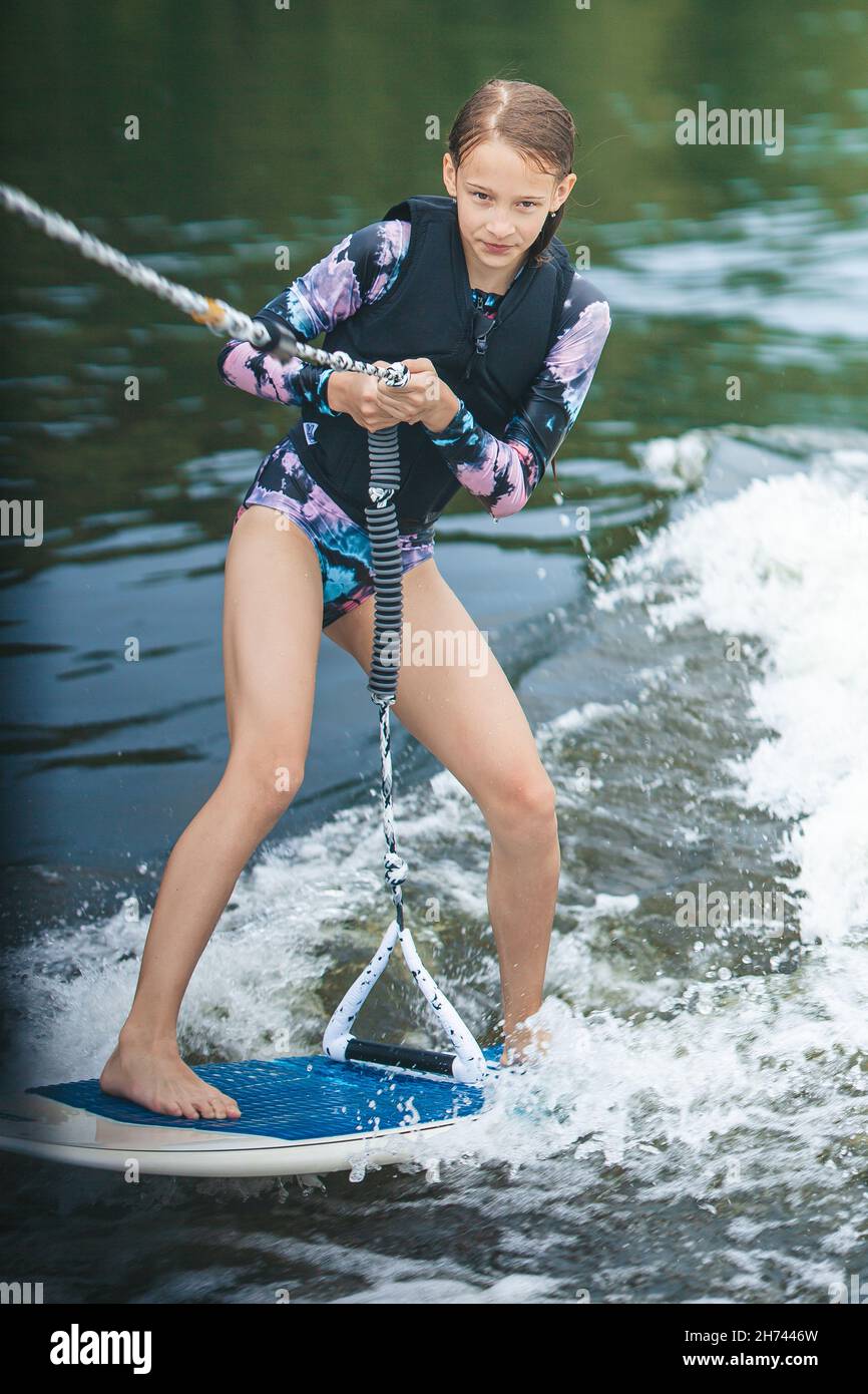 Active Beautiful Girl In The Swimsuit Standing On The Wakeboard In The