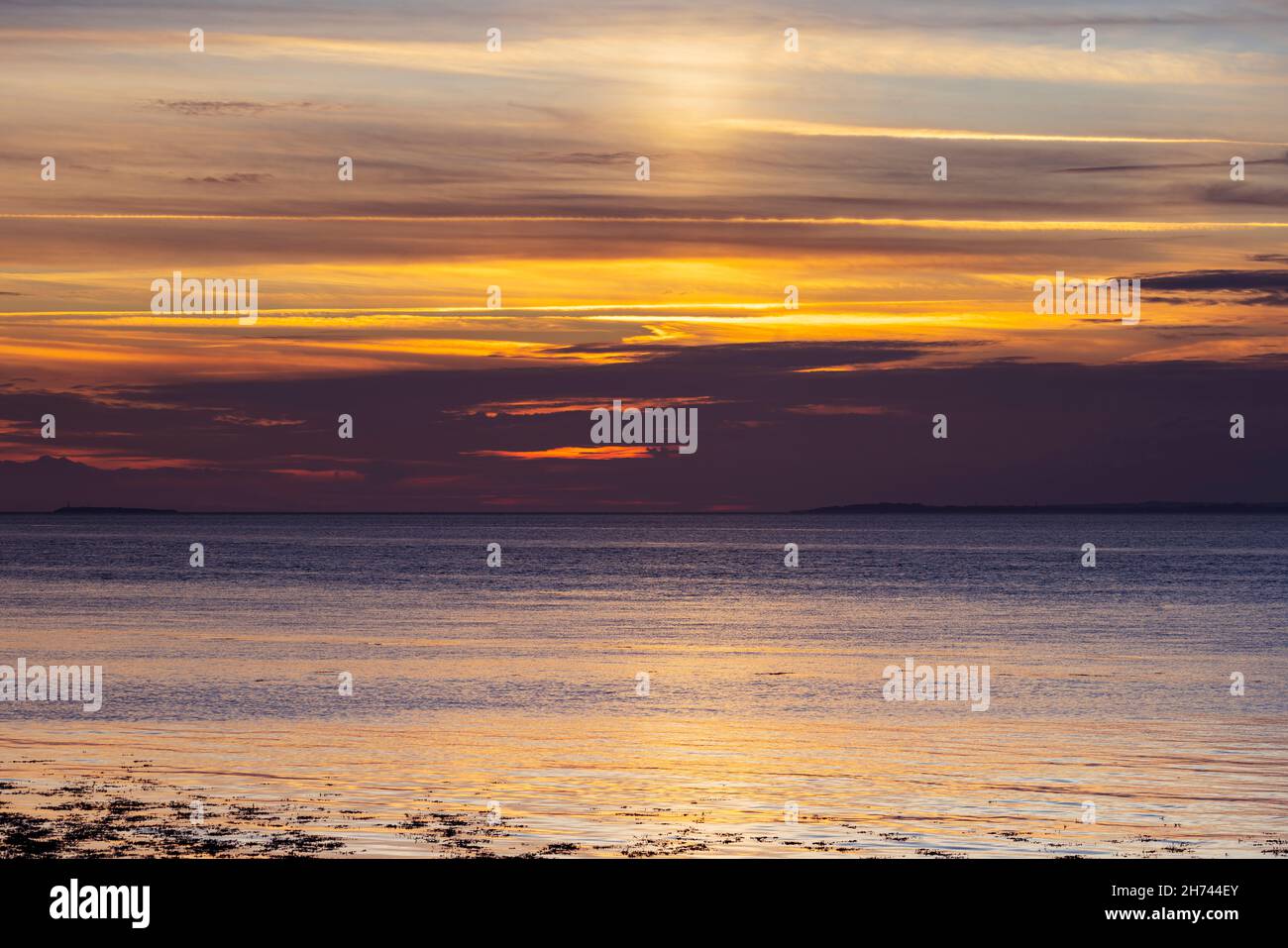 The setting sun lighting up the cloud cover Stock Photo - Alamy
