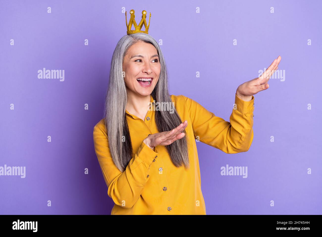 Portrait of attractive cheerful woman wearing crown dancing having fun ...