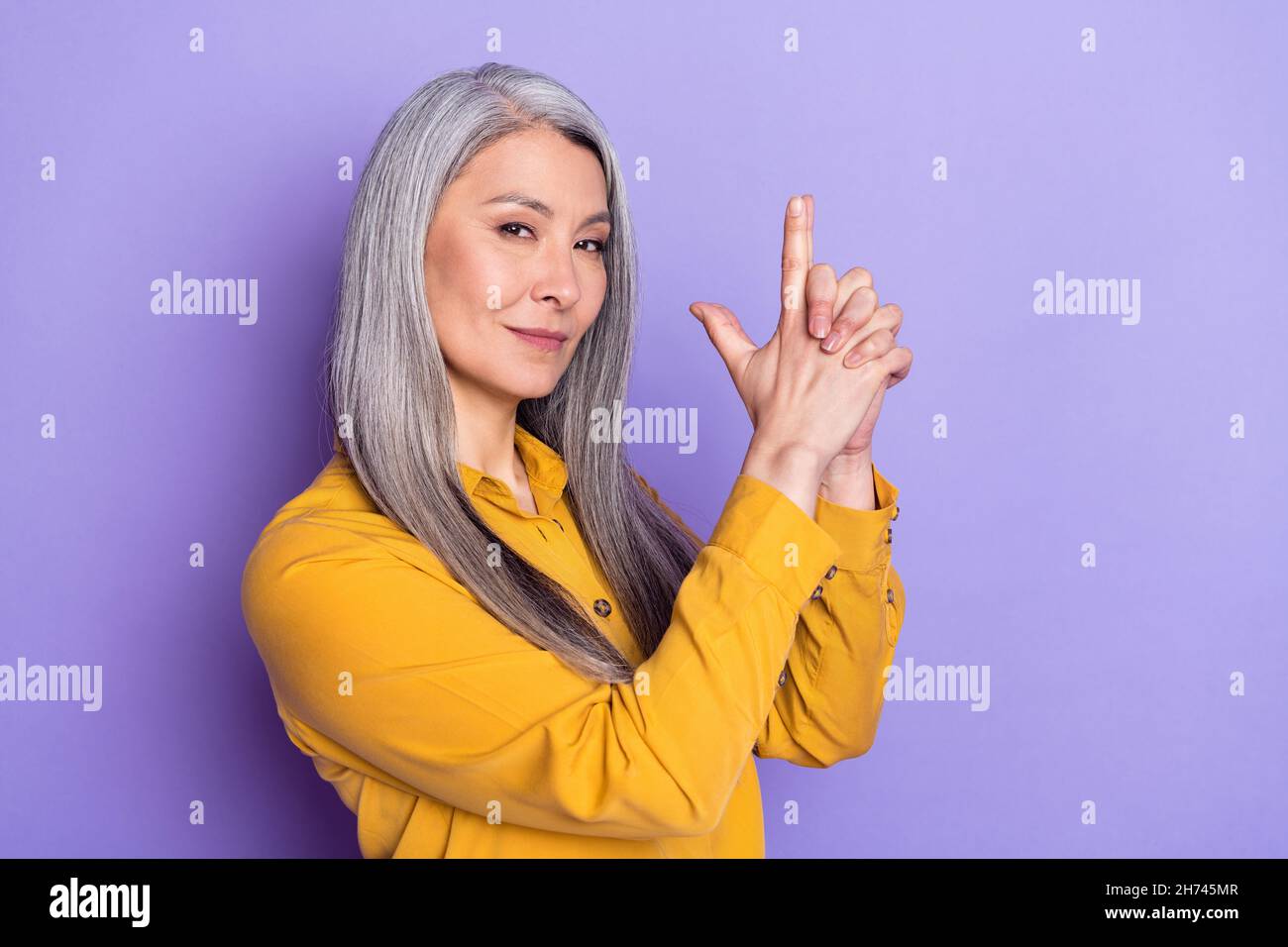 Profile side view portrait of attractive cunning woman showing gun sign ...
