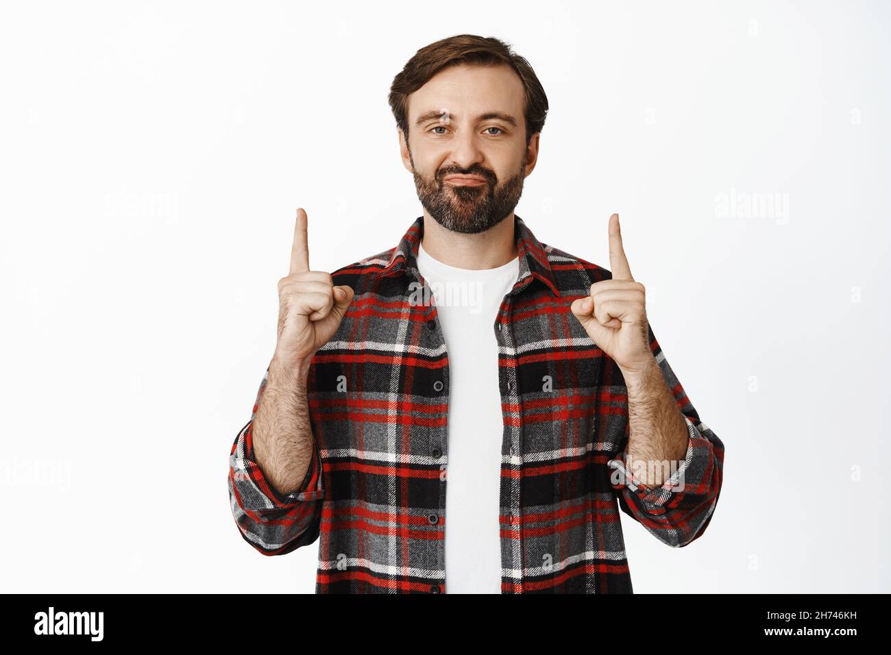 Disappointed adult man pointing fingers up, grimacing displeased ...