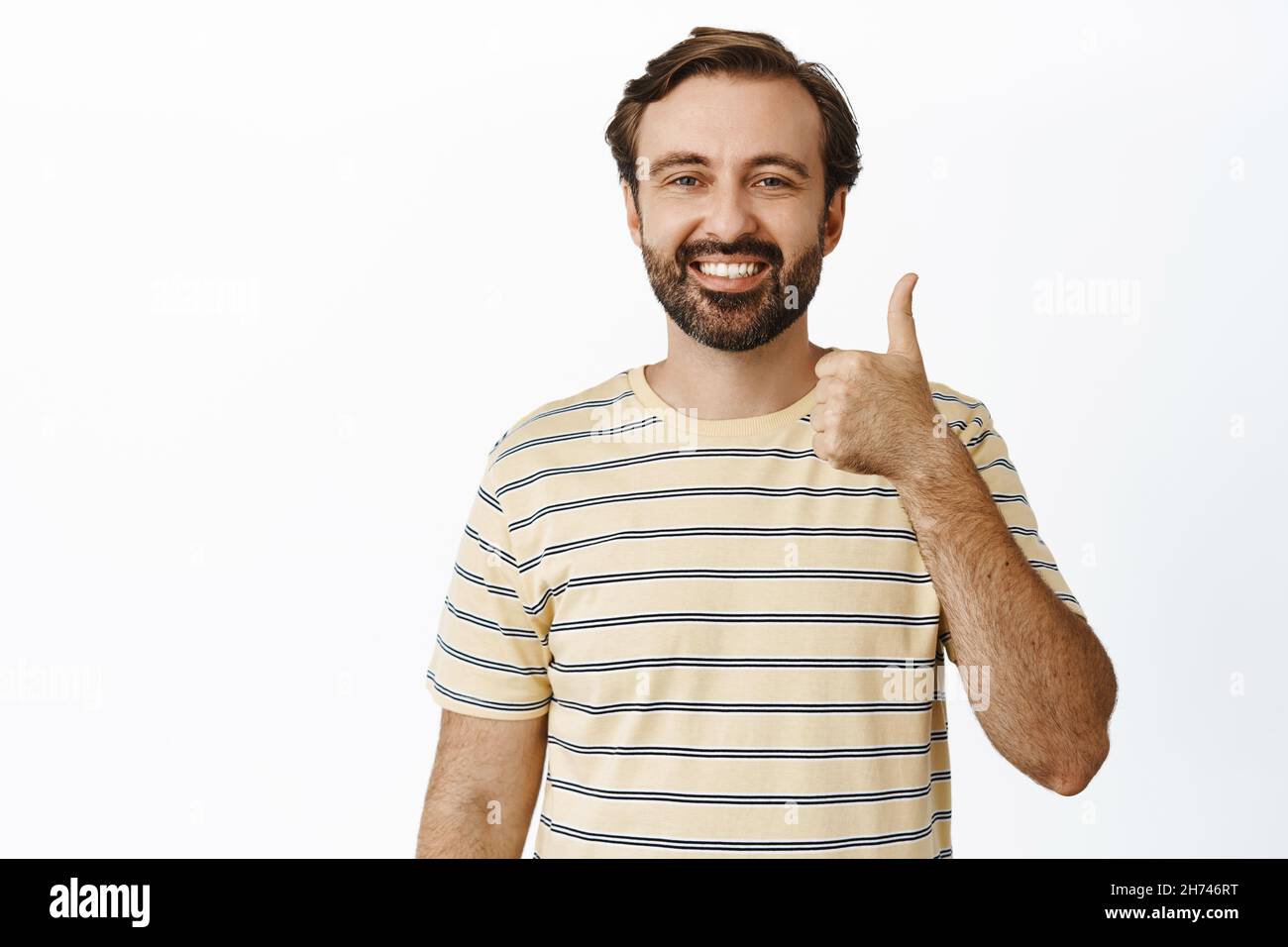 Smiling bearded man showing thumbs up in approval, like and agree ...