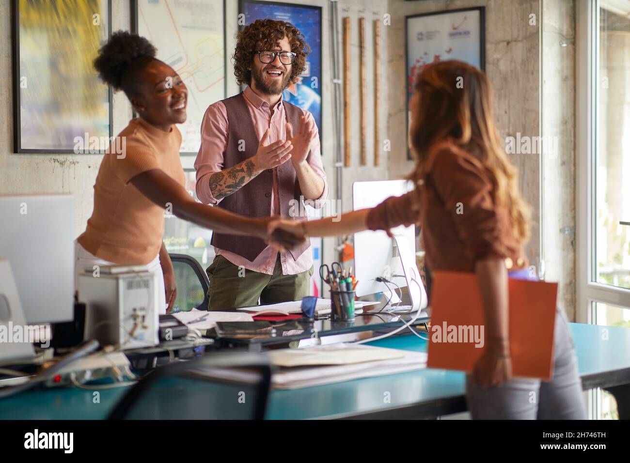 Young people at work are getting know with their new female colleague ...