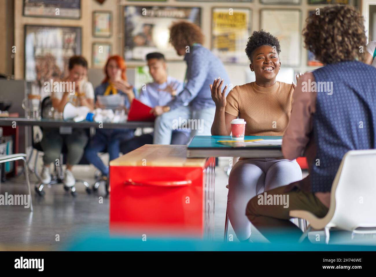 Young colleagues in a good mood while working in a friendly atmosphere ...